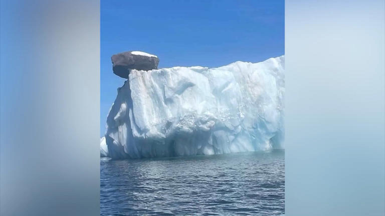 How did boulders wind up on top of this iceberg?