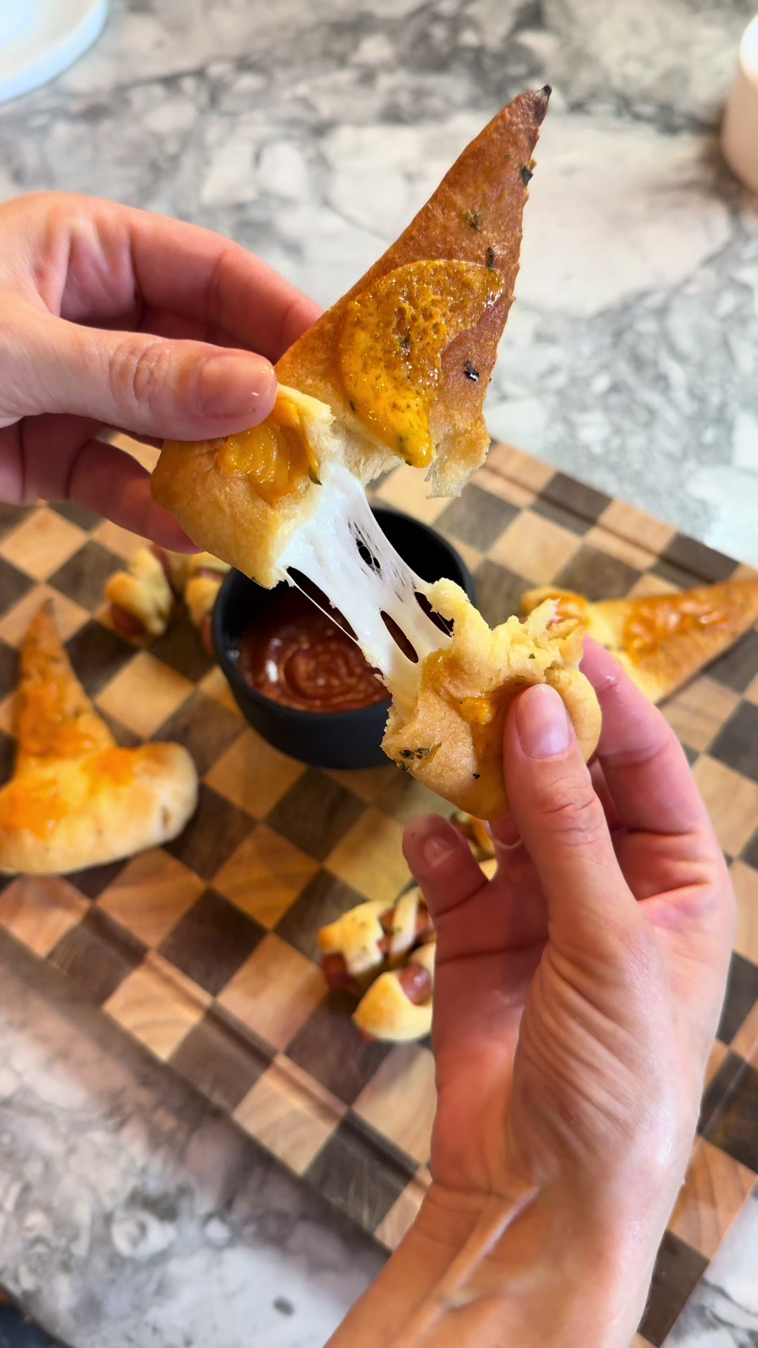 Cheese snacks decorated as tiny mummies for Halloween