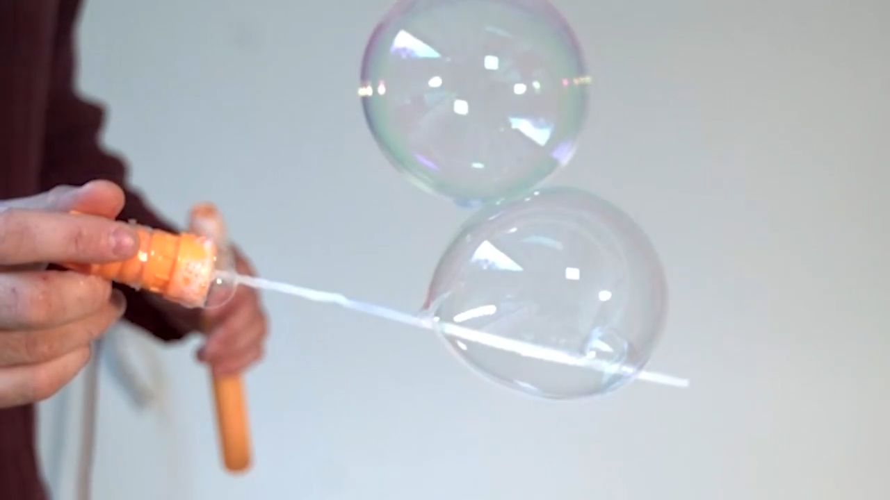 He filmed two bubbles touching… then the moment became mesmerizing