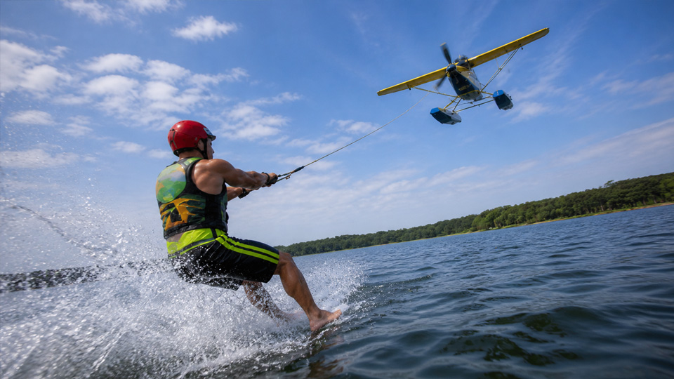 Barefoot skiing behind airplane shows extreme speed
