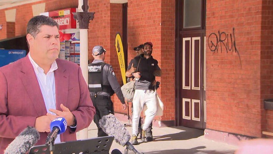 Graffiti protester crashes Queensland transport minister's live press ...