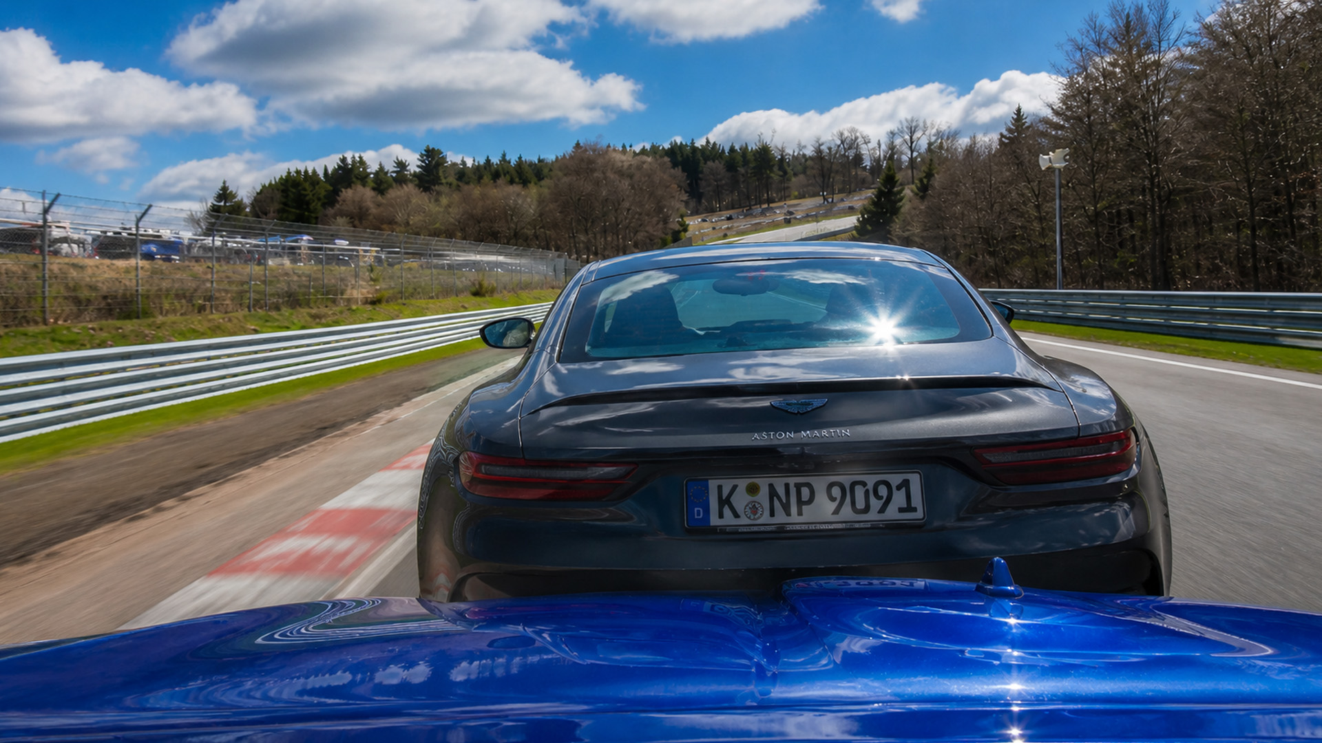 BMW X5M nearly collides with Aston Martin on track