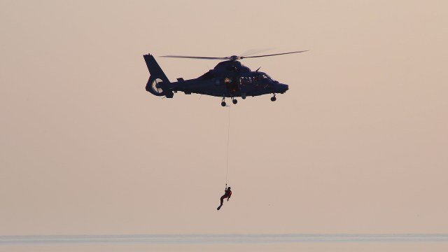 Police officer dangles from helicopter to retrieve human remains from ...