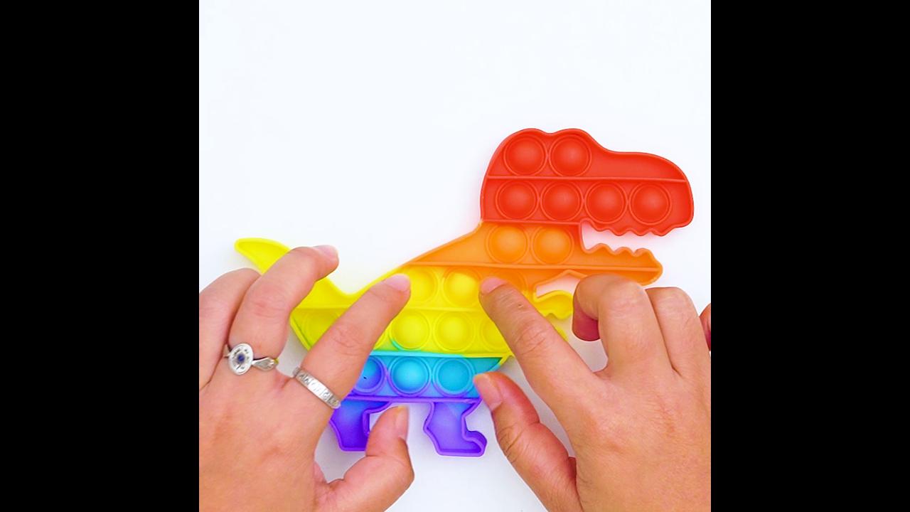 Pressing a rainbow dinosaur pop it with smooth bubble texture