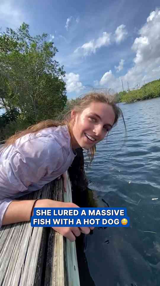 Woman attracts large fish using hot dog bait