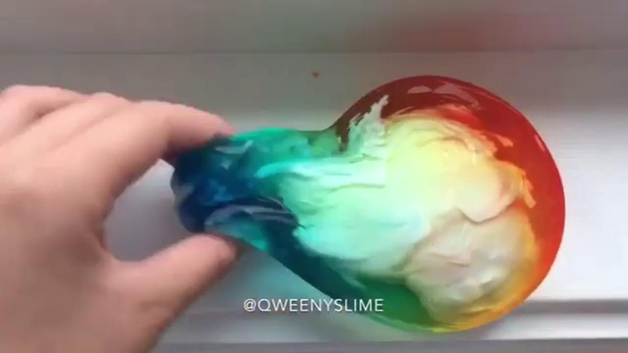 Squeezing And Blending Rainbow Slime In Container Creating Smooth Color ...