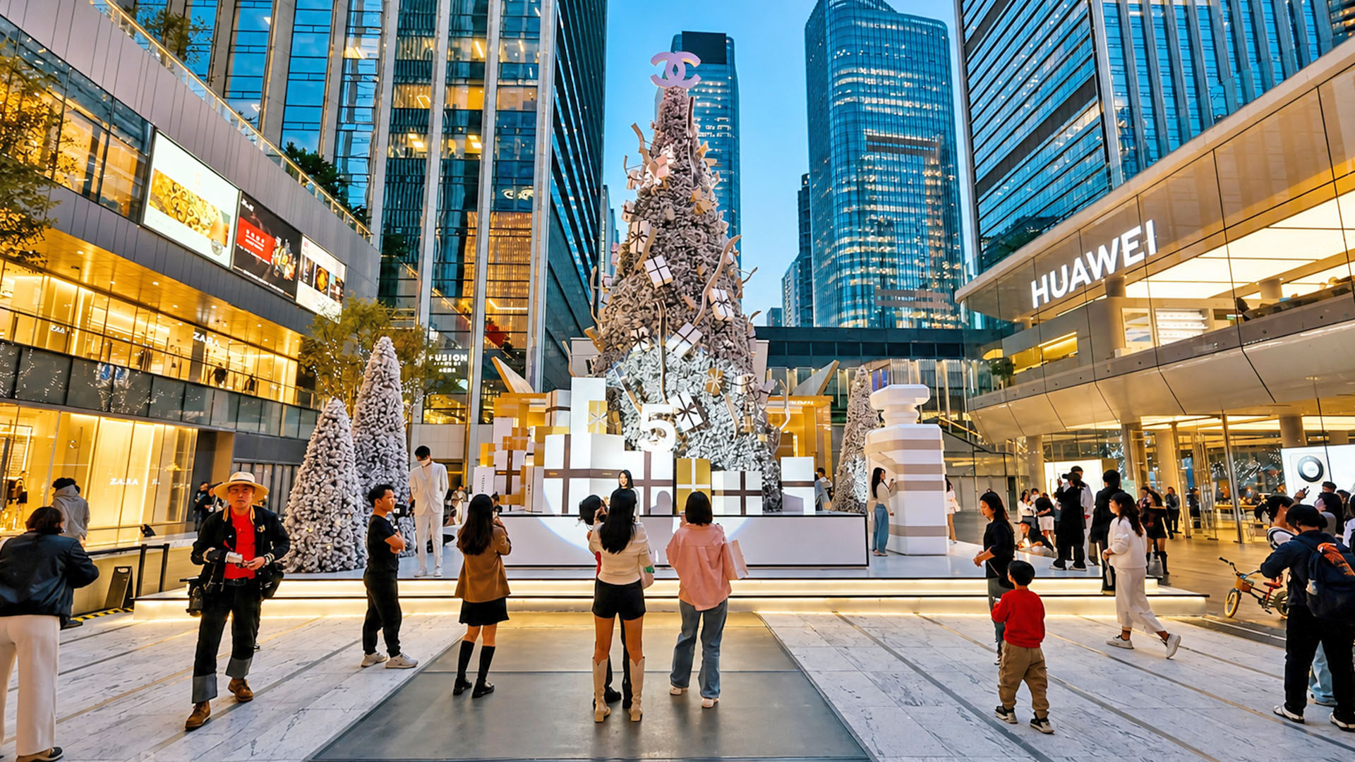 A public plaza filled with people around a seasonal decoration display