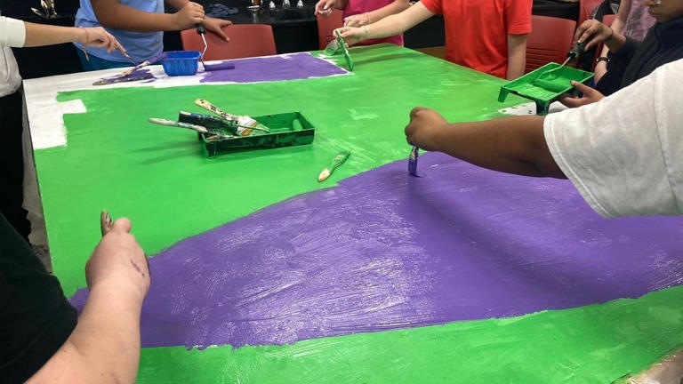 Students create murals to brighten South of 6 neighborhood in Iowa City