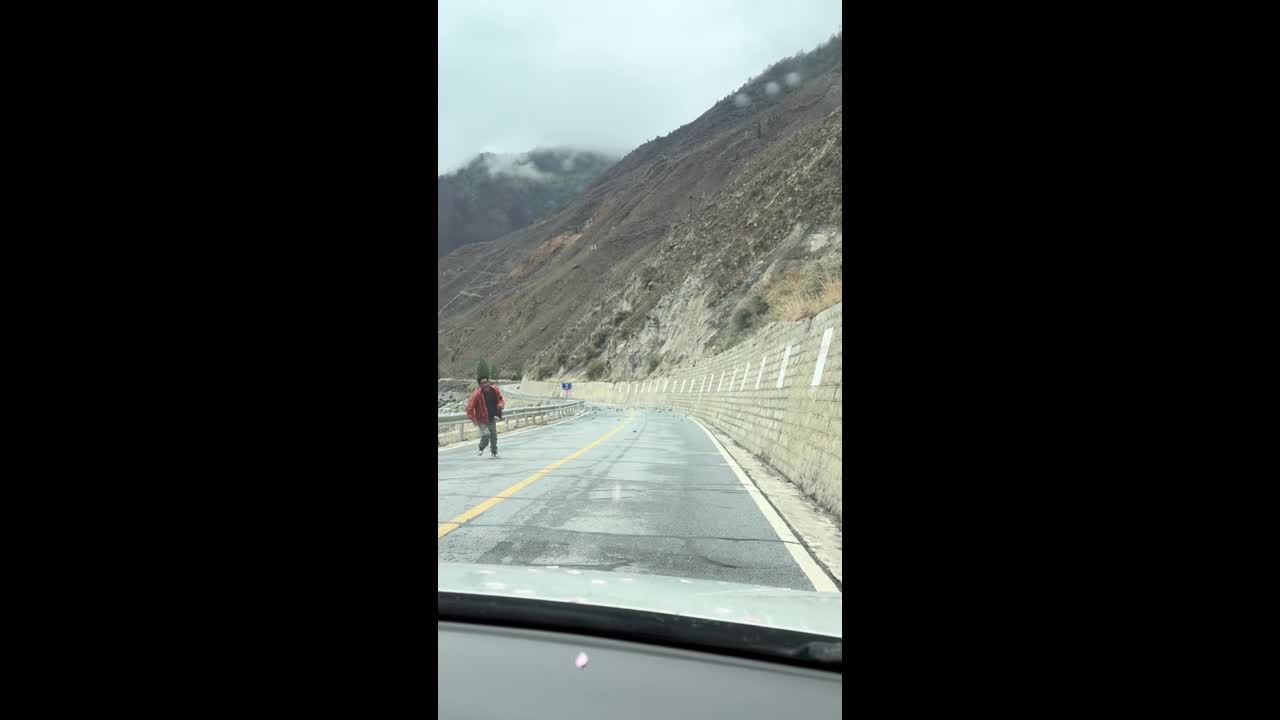 Falling rocks block mountain road in Tibet, China