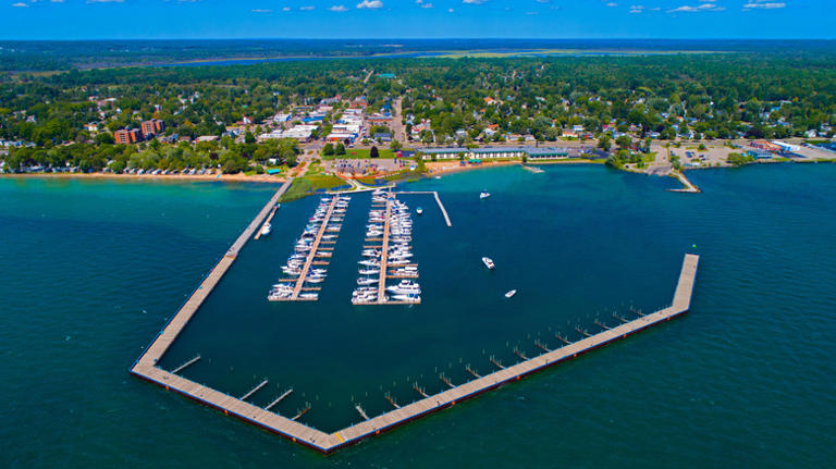 Nestled on Michigan's Sunrise Coast is a charming beach town nicknamed ...