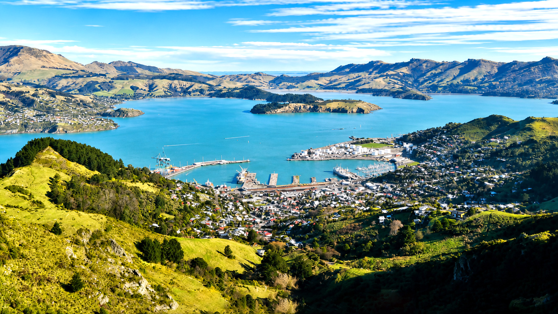 A hidden harbor town surrounded by volcanic hills