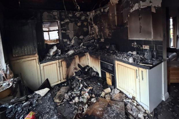 Devastating fire destroys kitchen as 'double-parked' cars hamper ...