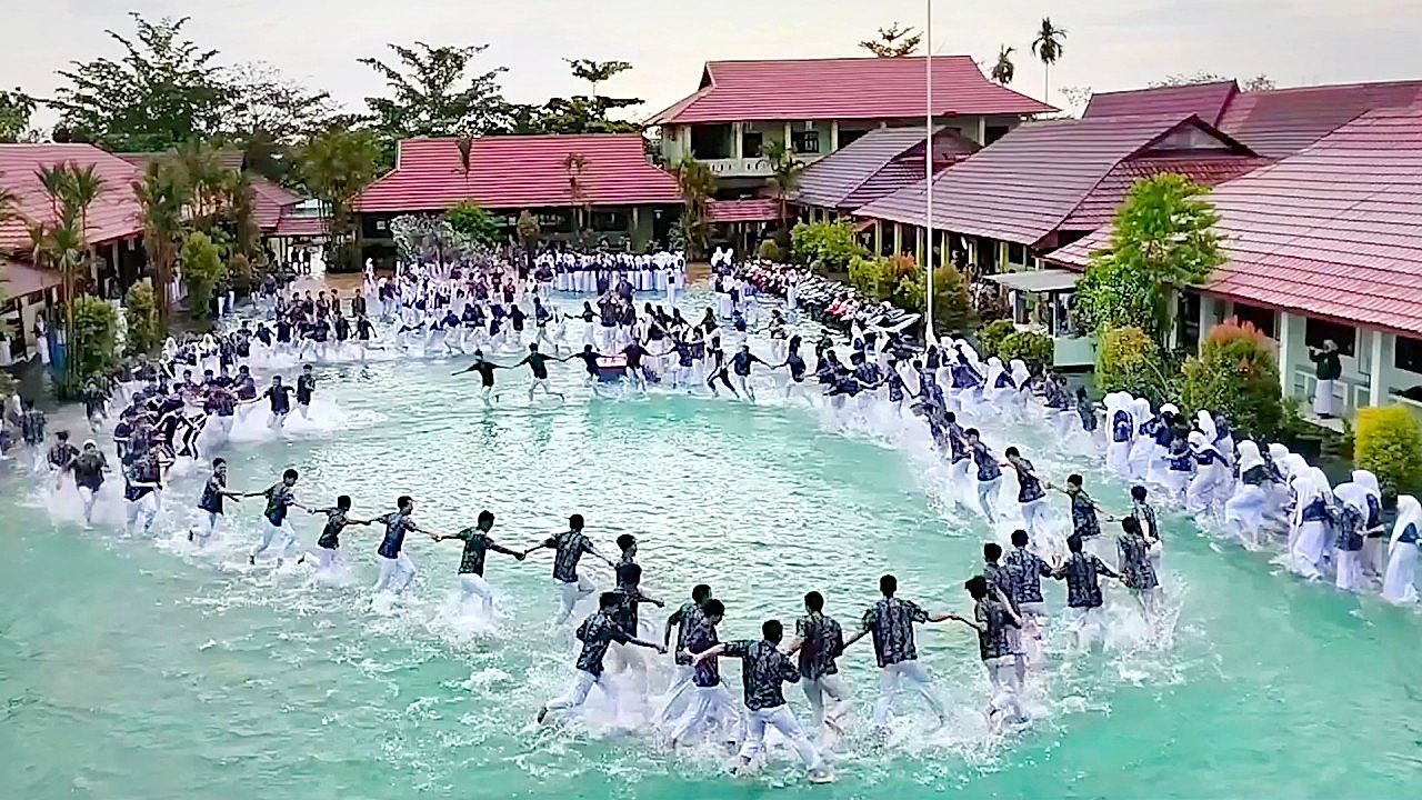 Flooded schoolyard turns into unexpected playground after heavy rain