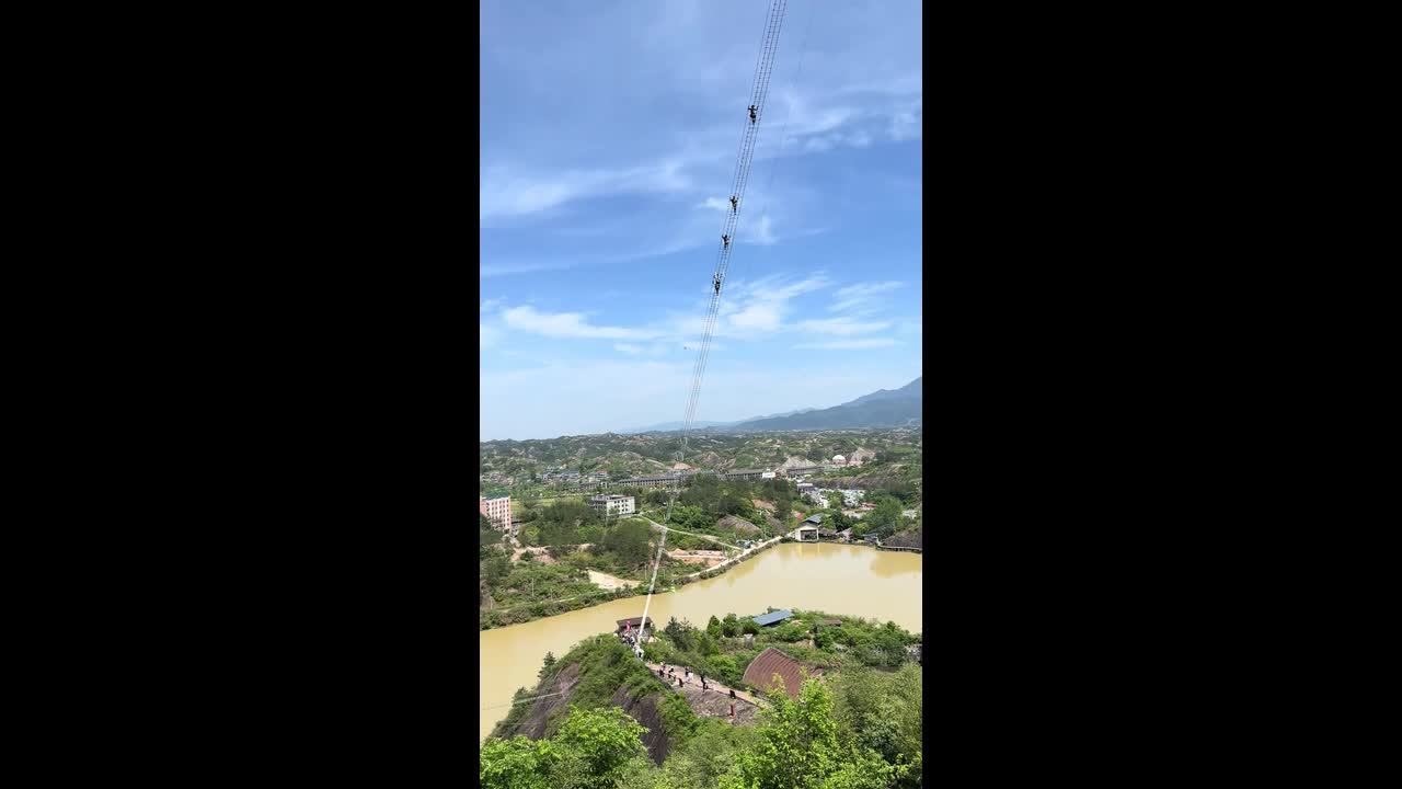 People climb steep sky ladder in Hunan, China