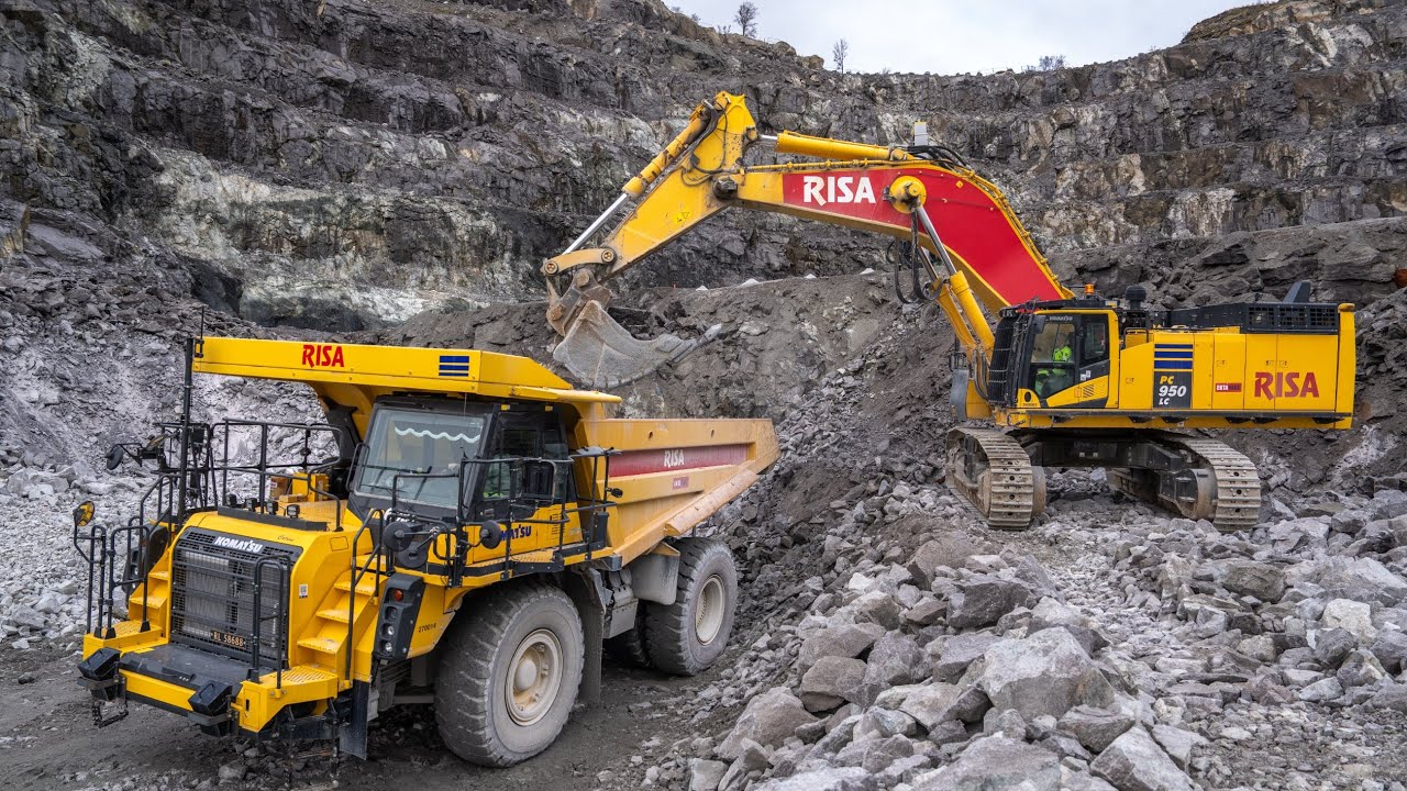 Heavy earthmoving equipment handling massive rock material