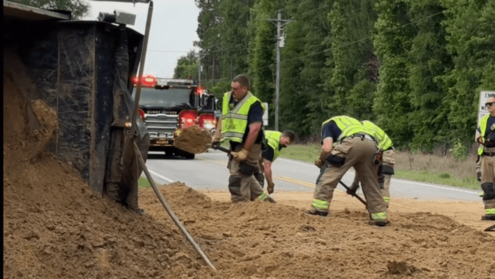 Dump truck filled with sand overturns in Aynor