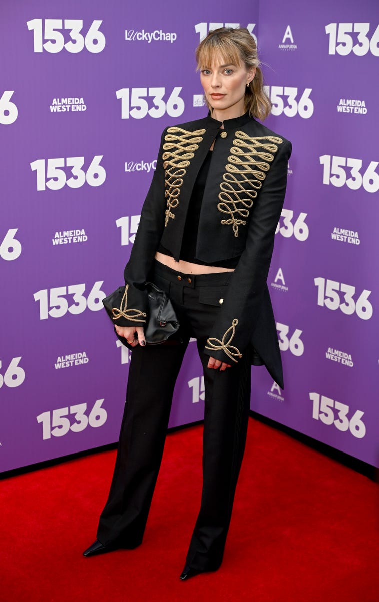 Margot Robbie wears ultra low-rise pants with a cropped military jacket