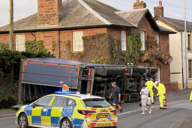 Overturned lorry causes 'minor damage' to nearby building
