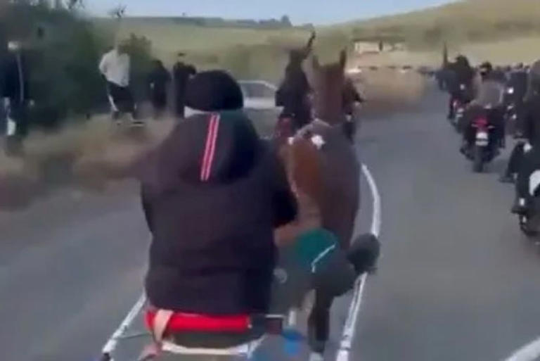 Mafia goons fire AK-47s from scooters in sick horse racing video