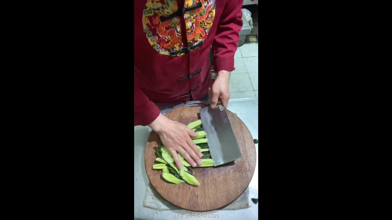 Slicing fresh cucumber lengthwise with sharp knife creating clean and ...