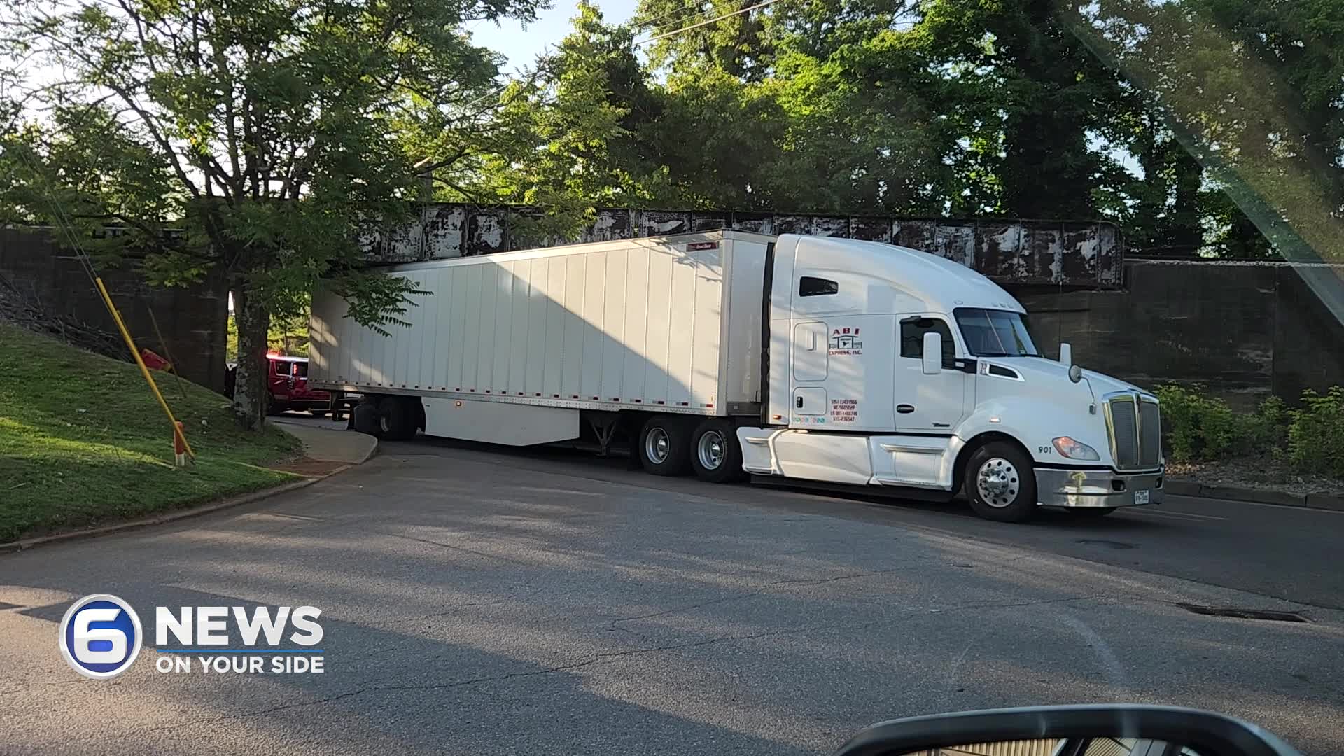 Truck stuck under train trestle on Central Street in Knoxville