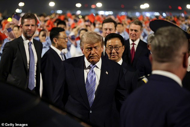 Trump smiles and fist pumps as he's greeted by 300 chanting Chinese ...