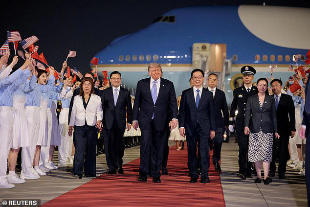 Trump smiles and fist pumps as he's greeted by 300 chanting Chinese ...