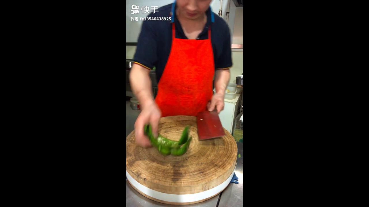 Chopping green pepper into thick segments on wooden board with clean ...