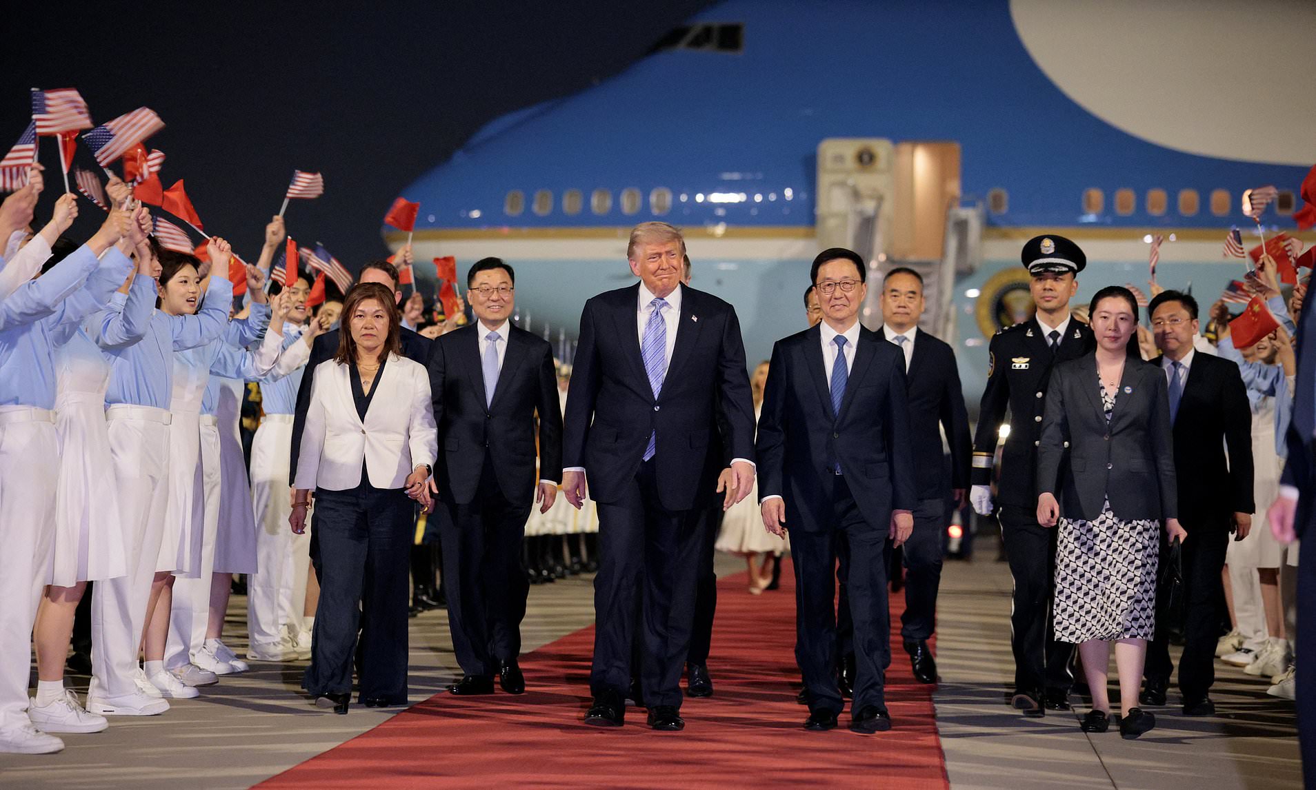 Trump smiles and fist pumps as he's greeted by 300 chanting Chinese ...