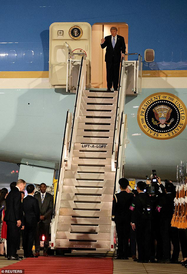 Trump smiles and fist pumps as he's greeted by 300 chanting Chinese ...