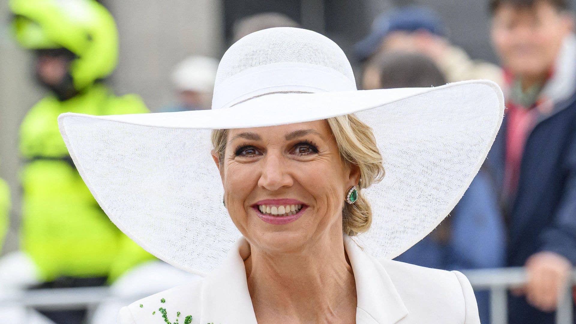 Queen Máxima surprises in bridal white suit - splashed with green paint