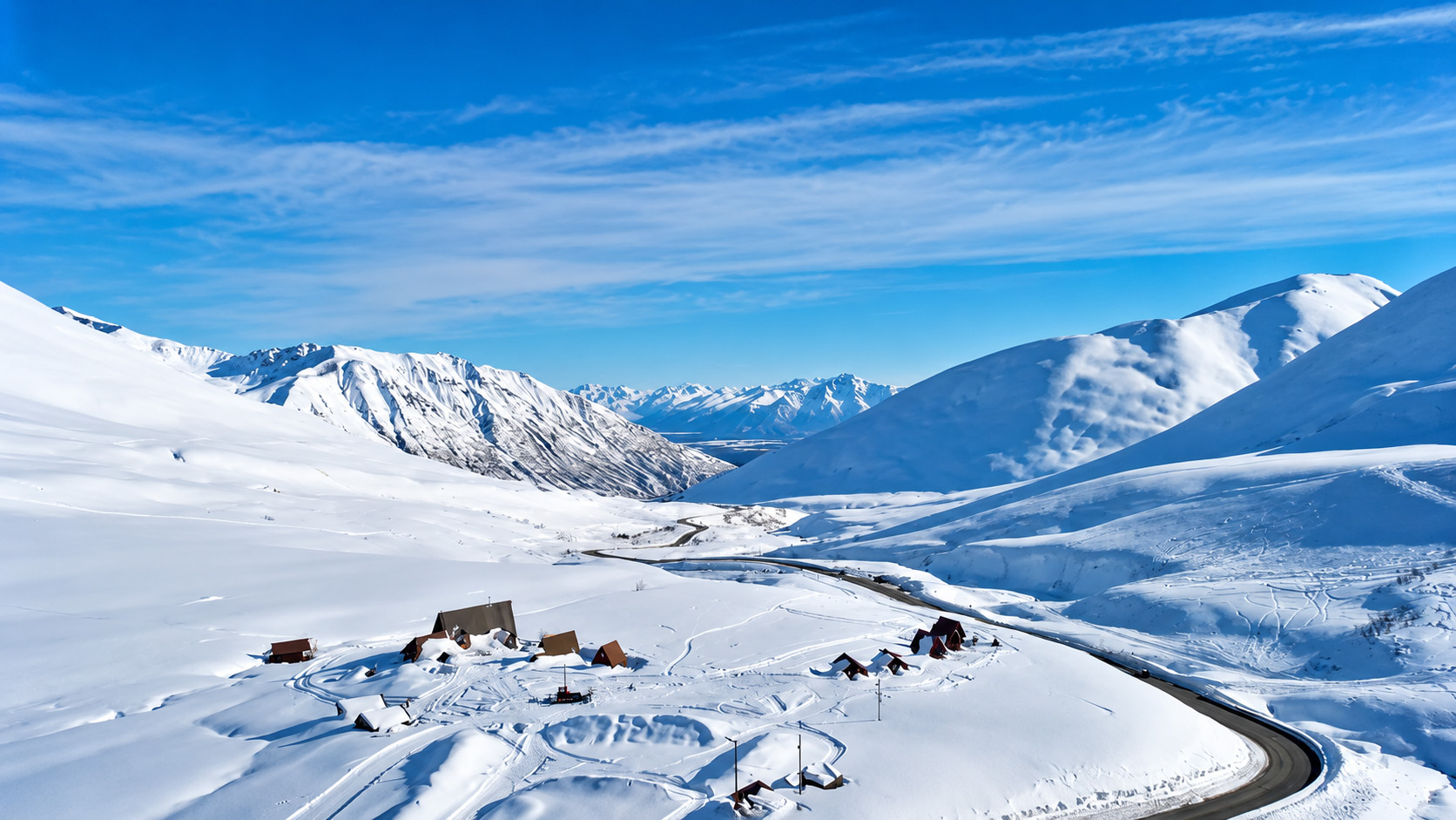 A remote road winding through Alaska’s frozen terrain
