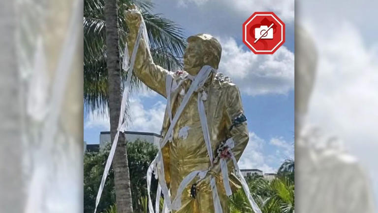 Was golden Trump statue vandalized with garbage, as shown in image?