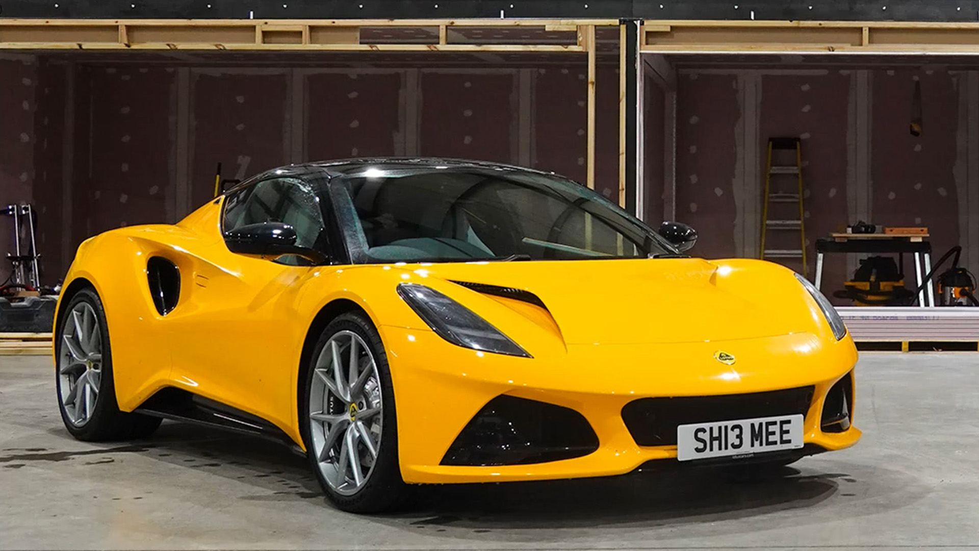 Yellow Lotus Emira first edition in luxury supercar garage