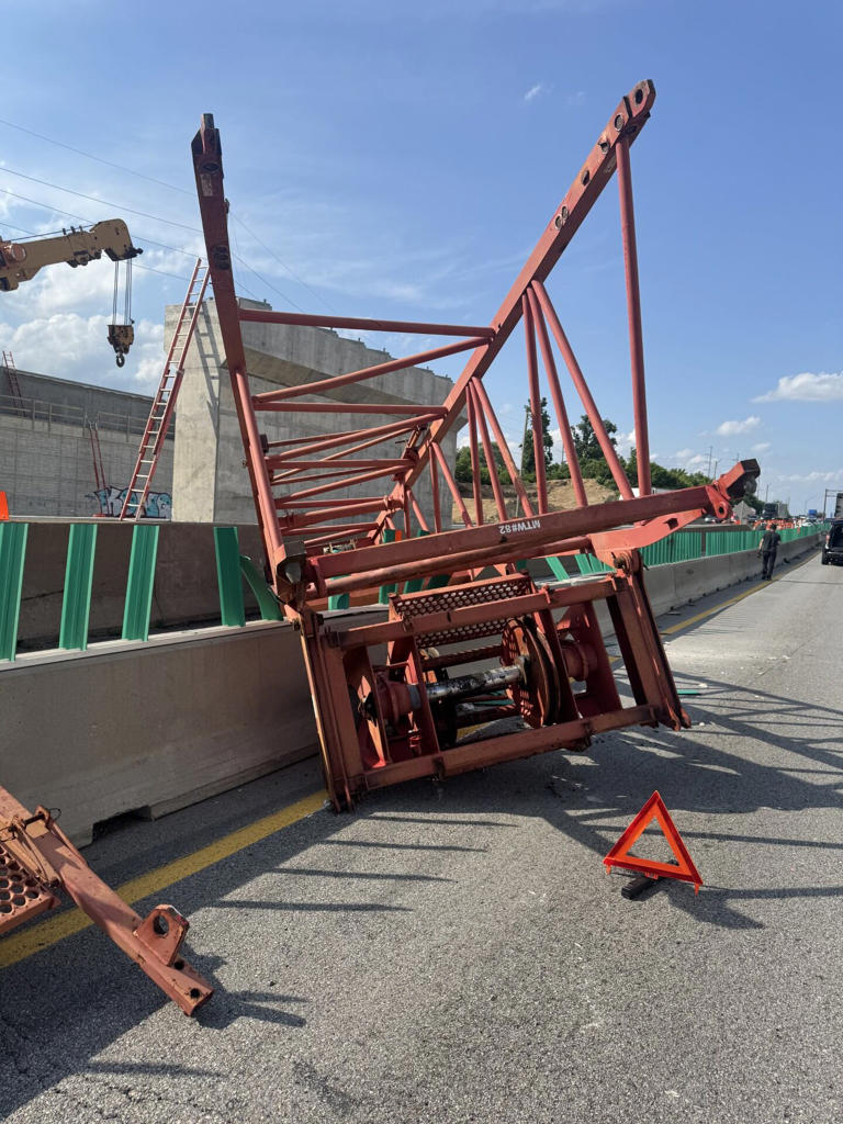 Truck carrying crane hits bridge on I-75
