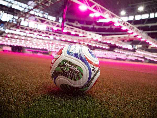 AT&T Stadium glows pretty in pink as World Cup field takes root
