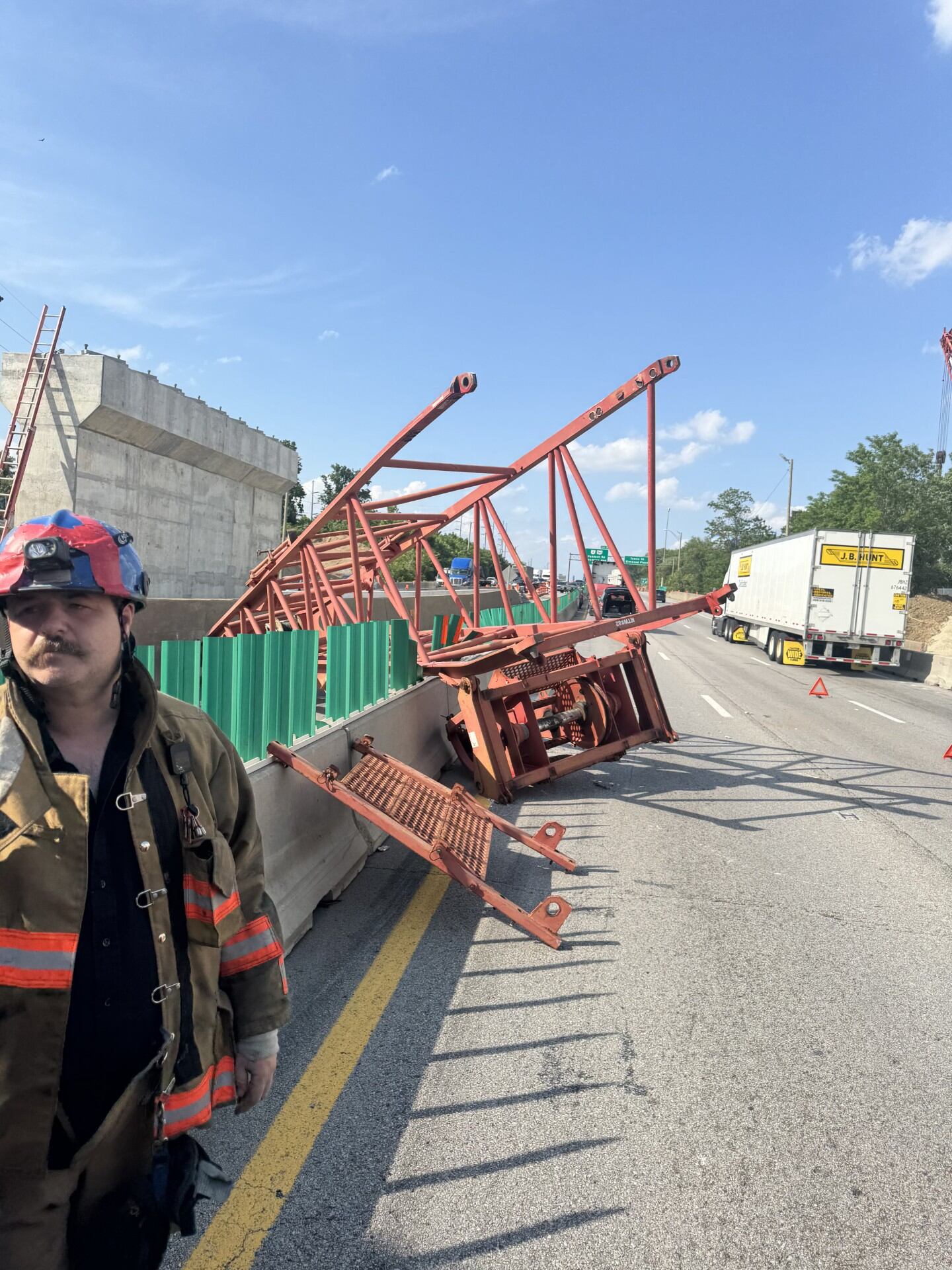Truck carrying crane hits bridge on I-75