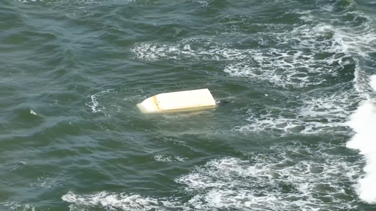 Four boaters and a dog rescued after boat capsizes near Oak Island