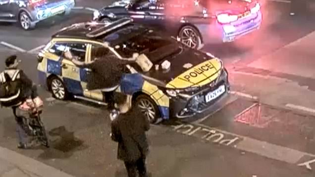 Man caught on CCTV kicking wing mirror off police car directly outside ...