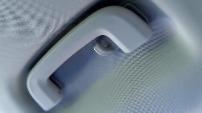 What are the hooks next to car grab handles for?