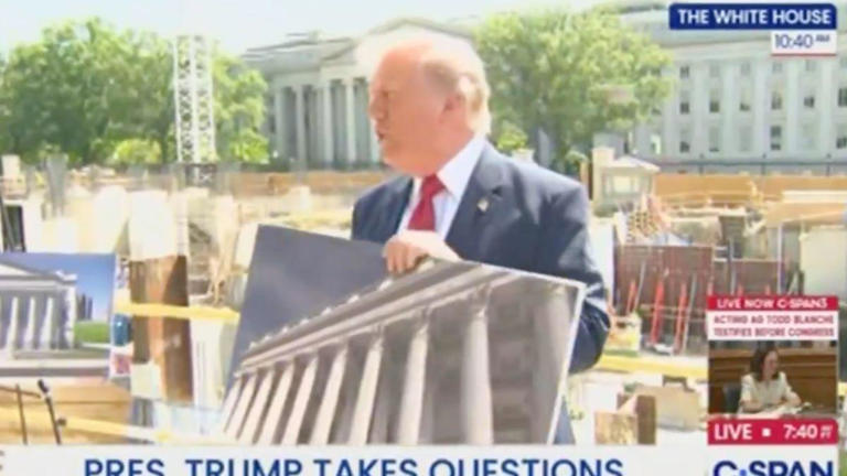 Donald Trump holds poster to hide his body during press briefing amid ...