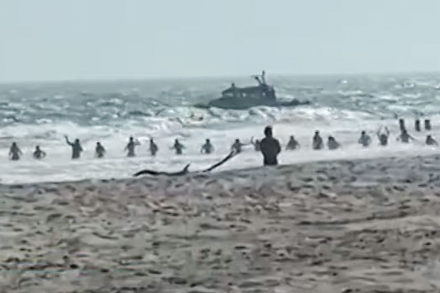 Rescue team forms human chain amid search for 17-year-old swimmer who ...