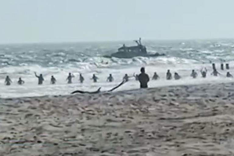 Rescue team forms human chain amid search for 17-year-old swimmer who ...