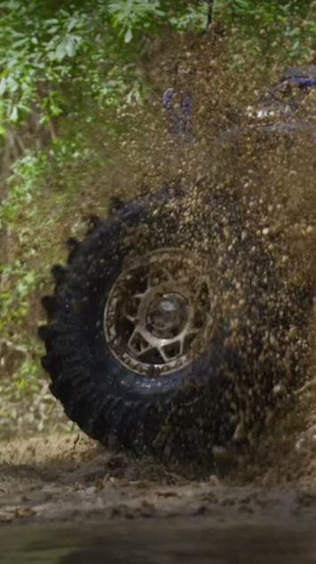 Skimming across the mud hole Can-Am Outlander XMR