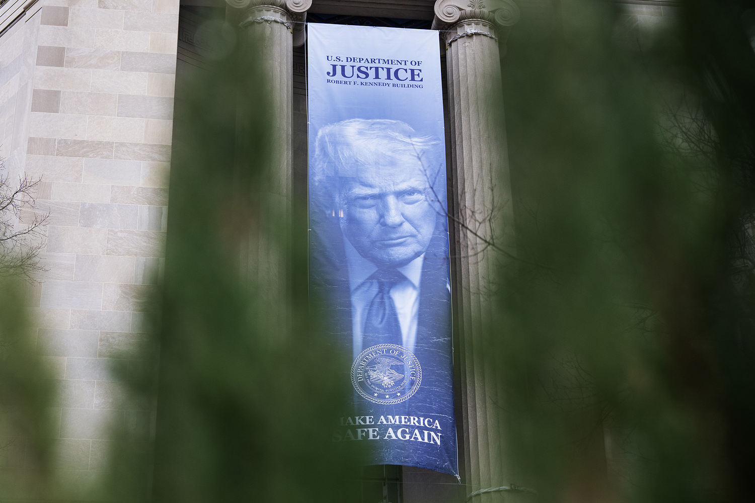 John Adams quote projected on DOJ building in protest of $1.8B fund