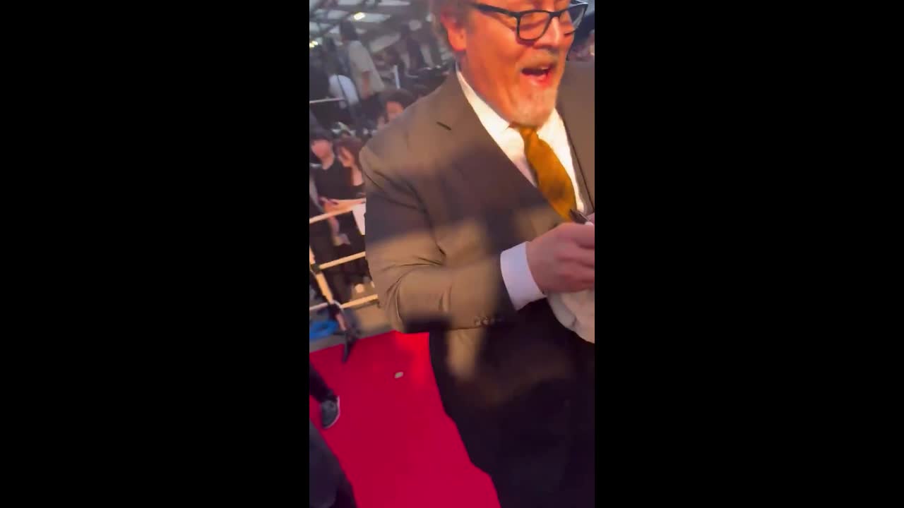 Star Wars director signs fan's Baby Yoda toy on premiere day