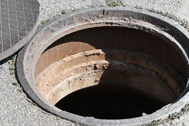 Truck likely knocked manhole cover loose before fatal fall