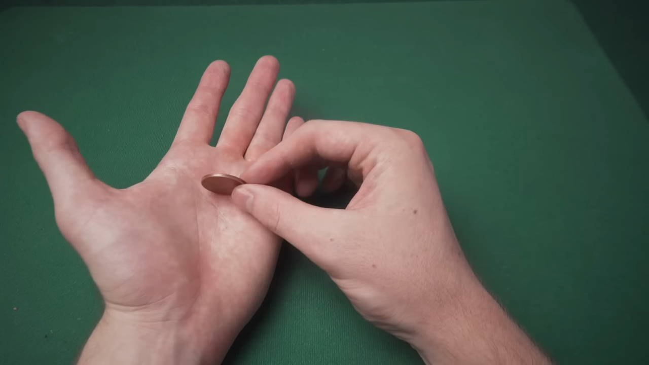 The coin never went into his hand - but everyone believed it did