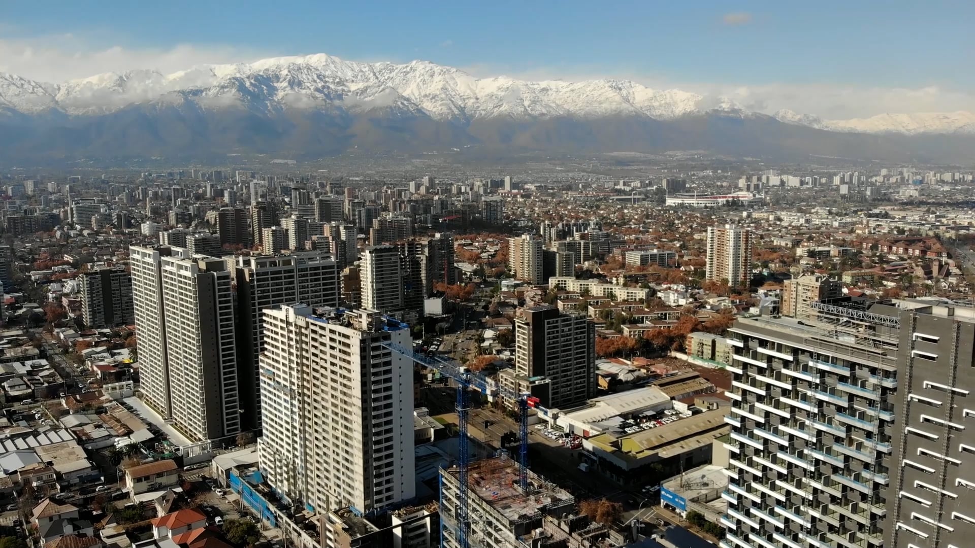 Drone soars over Santiago and the snow-capped Andes mountains