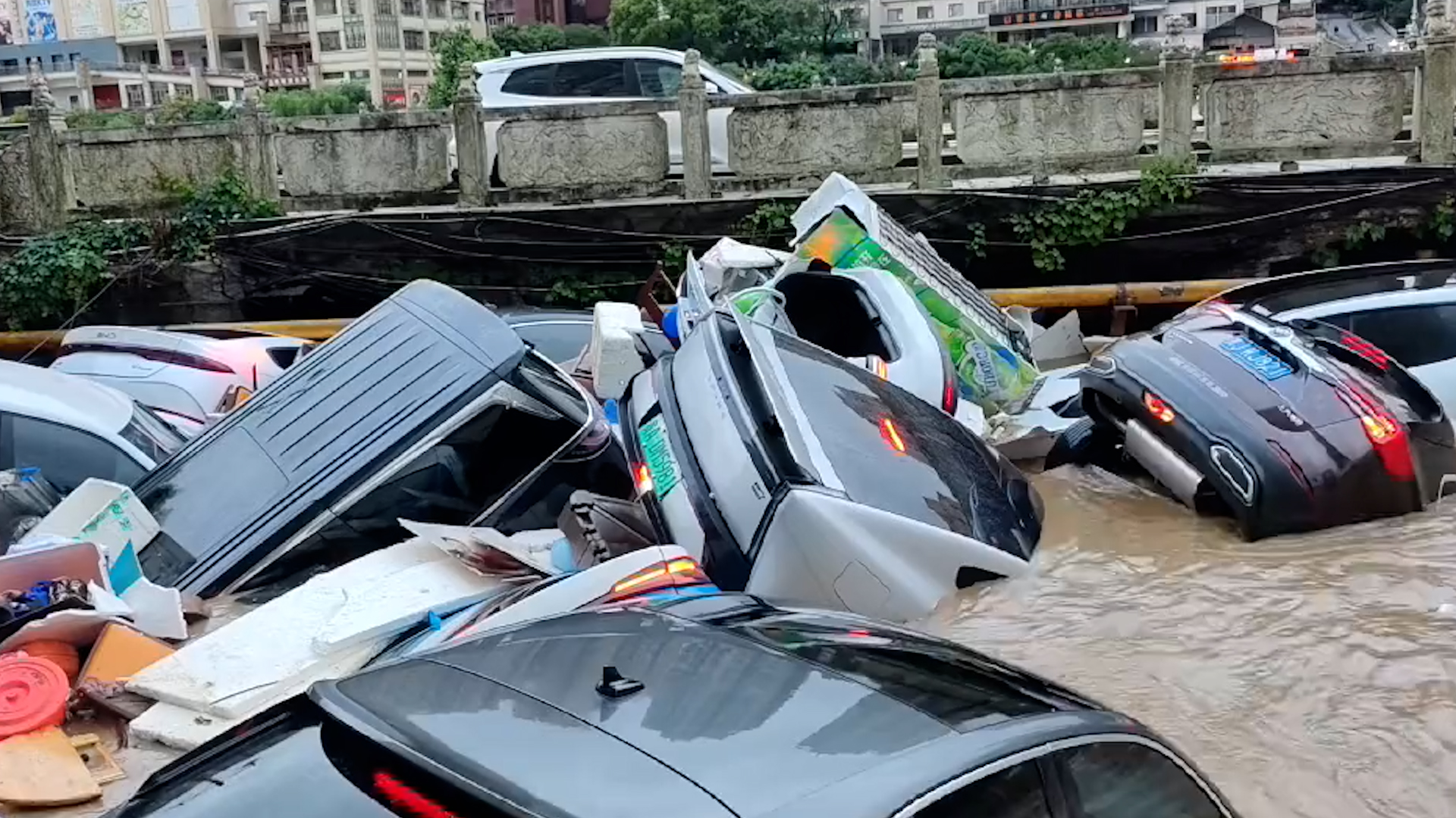 Cars swept into massive pileup during flash flooding in China